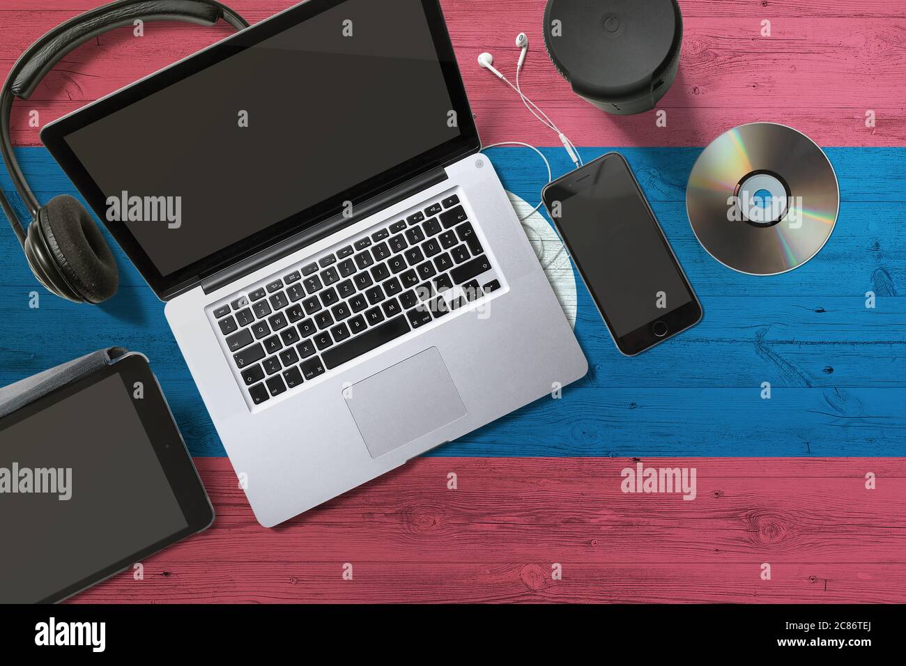 Laos flag on national background wooden table. Portable devices concept ...