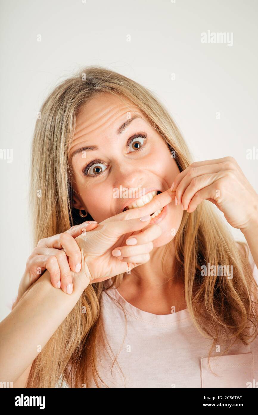 closeup portrait picture of woman biting finger of her sister Stock ...