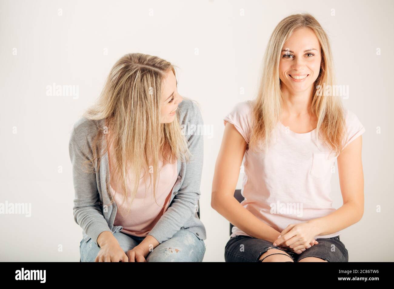 Beautiful two twins sisters together, one woman looking on another ...
