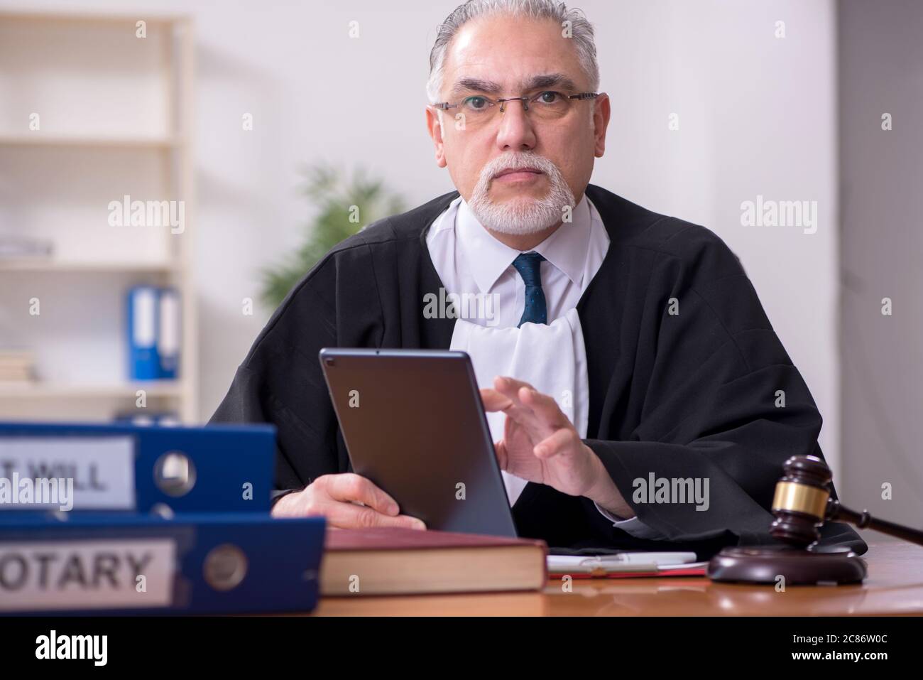 Old judge working in courthouse Stock Photo - Alamy