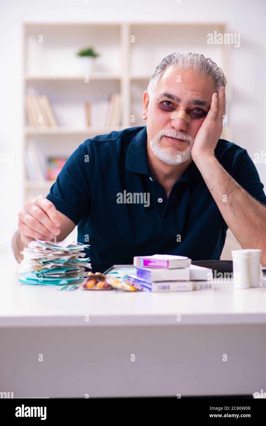 Old man in budget planning concept Stock Photo - Alamy
