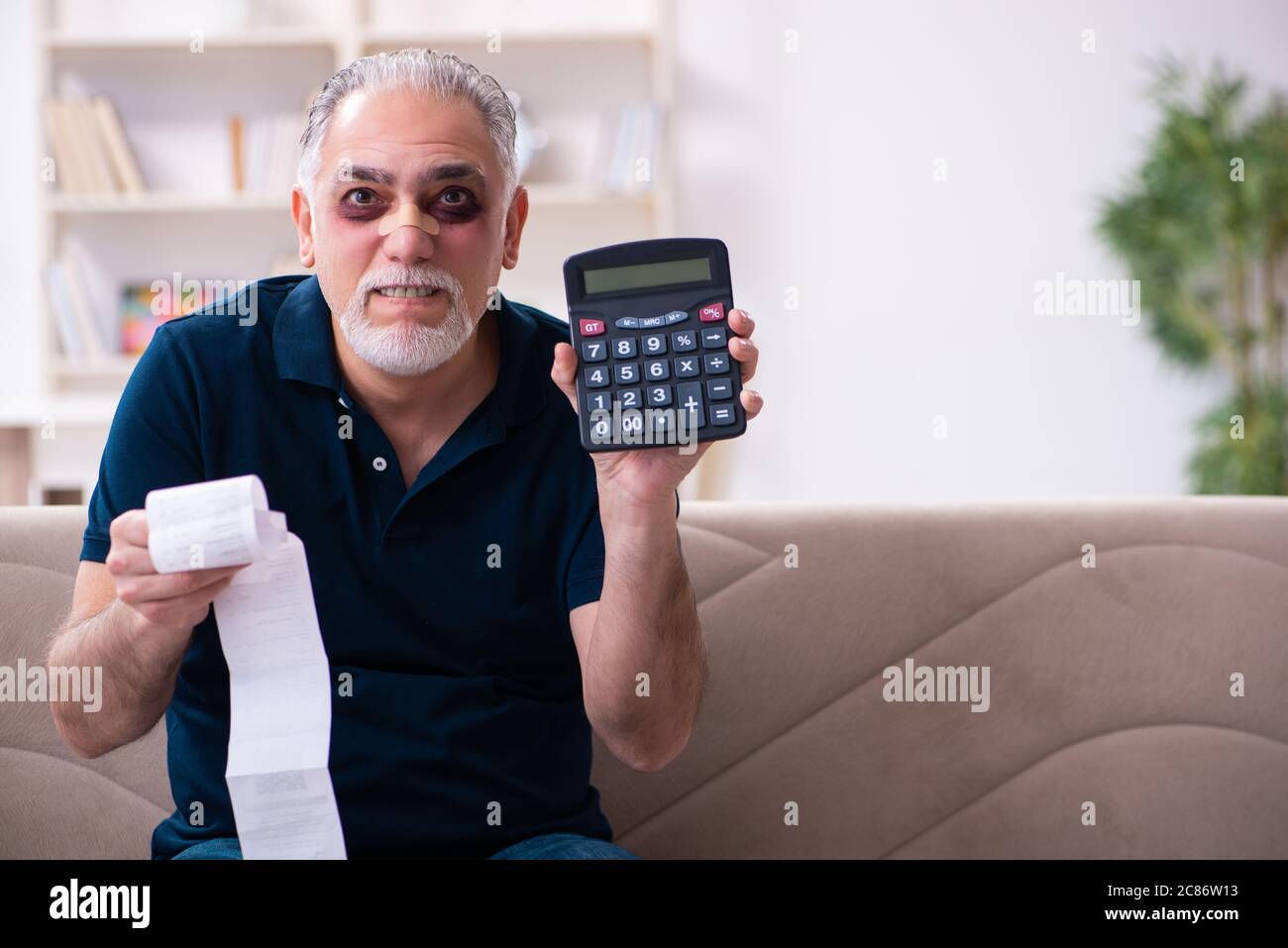 Old man in budget planning concept Stock Photo - Alamy