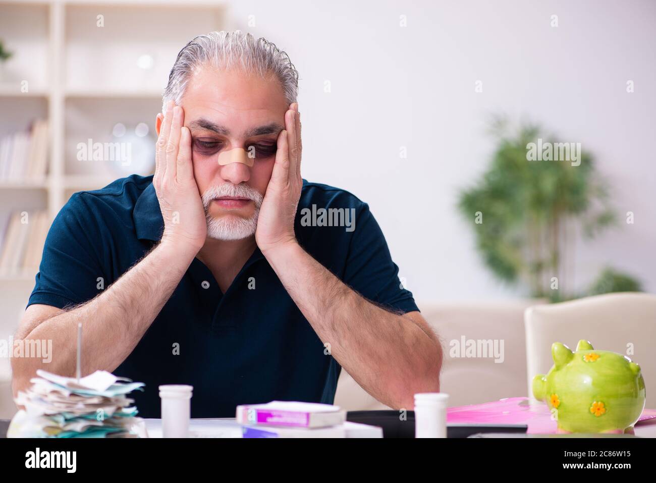 Old man in budget planning concept Stock Photo - Alamy