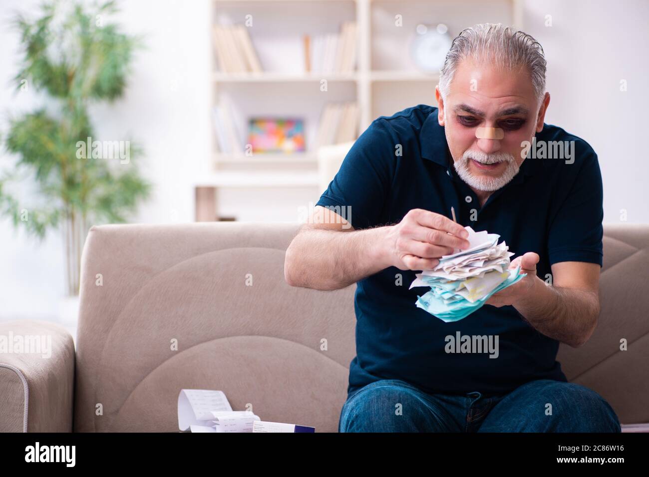 Old man in budget planning concept Stock Photo - Alamy