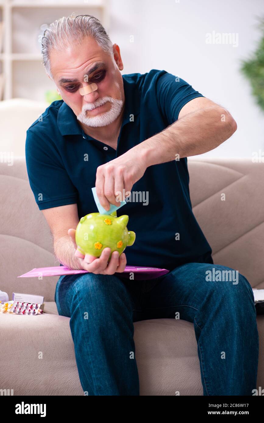 Old man in budget planning concept Stock Photo - Alamy