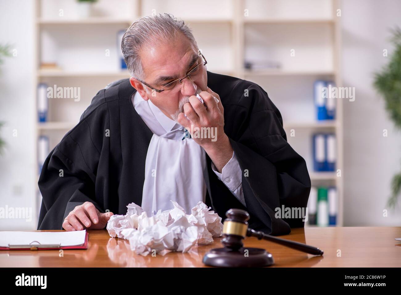 Old male judge working in the courthouse Stock Photo - Alamy
