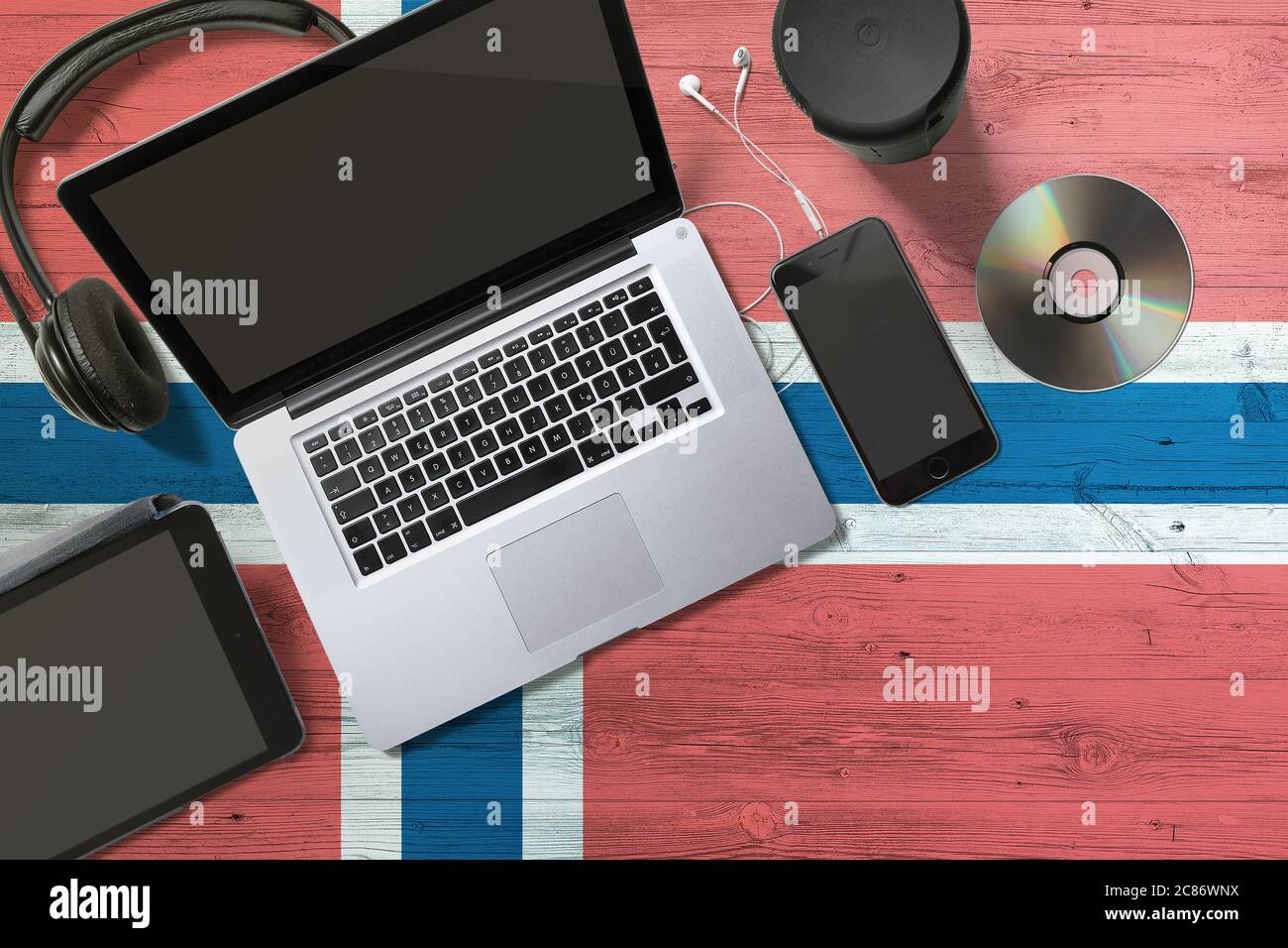 Norway flag on national background wooden table. Portable devices ...