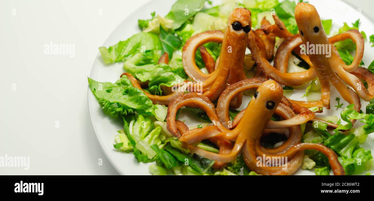 Creative meal for a child, fried sausages in an octopus shape served ...