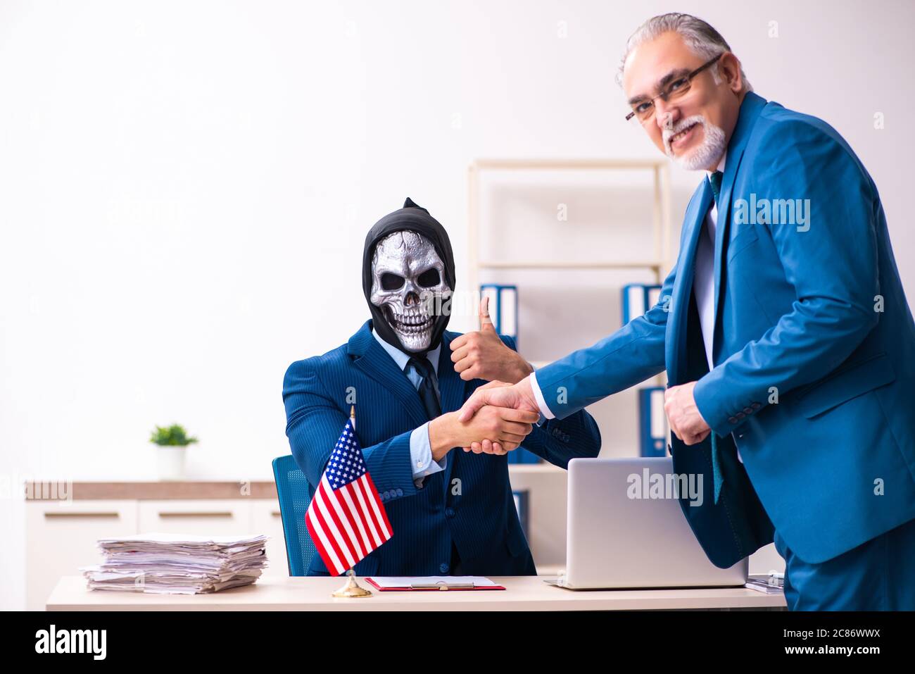 Old businessman employee making deal with the devil Stock Photo - Alamy