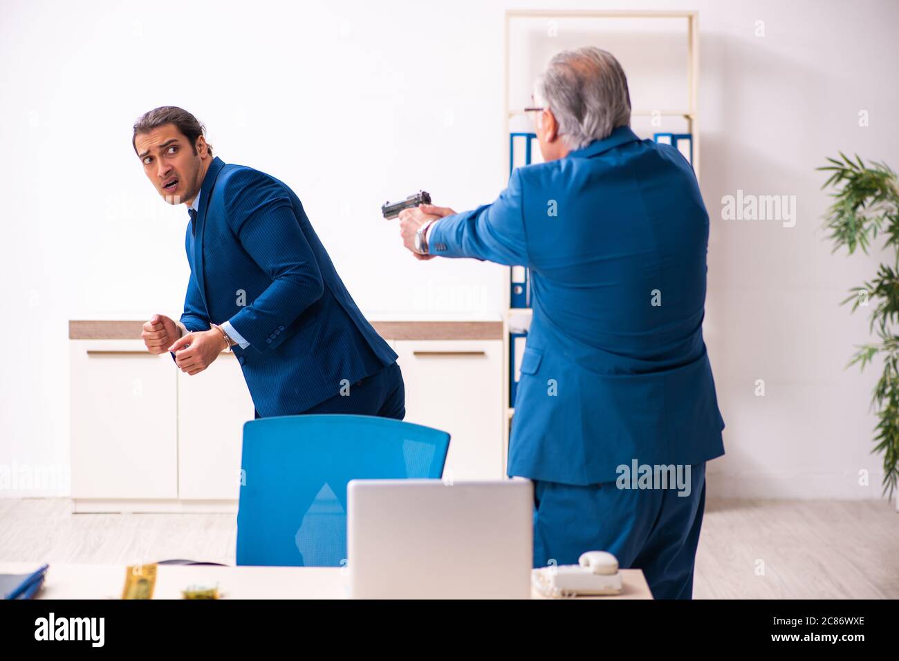 Male employee and cop in police investigation Stock Photo - Alamy