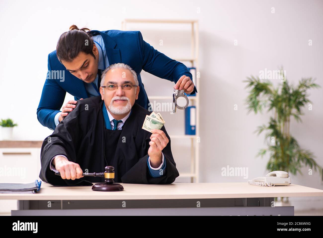 Police inspector arresting judge in court Stock Photo - Alamy