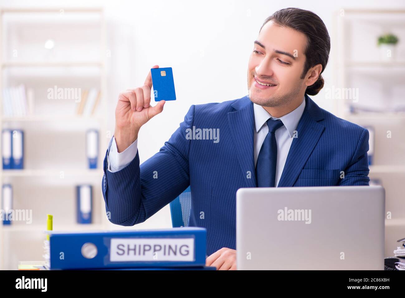 Young logistics specialist working in the office Stock Photo - Alamy