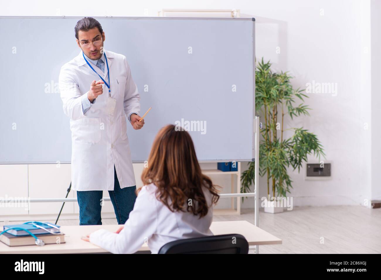 Young teacher doctor and female student in the classroom Stock Photo ...