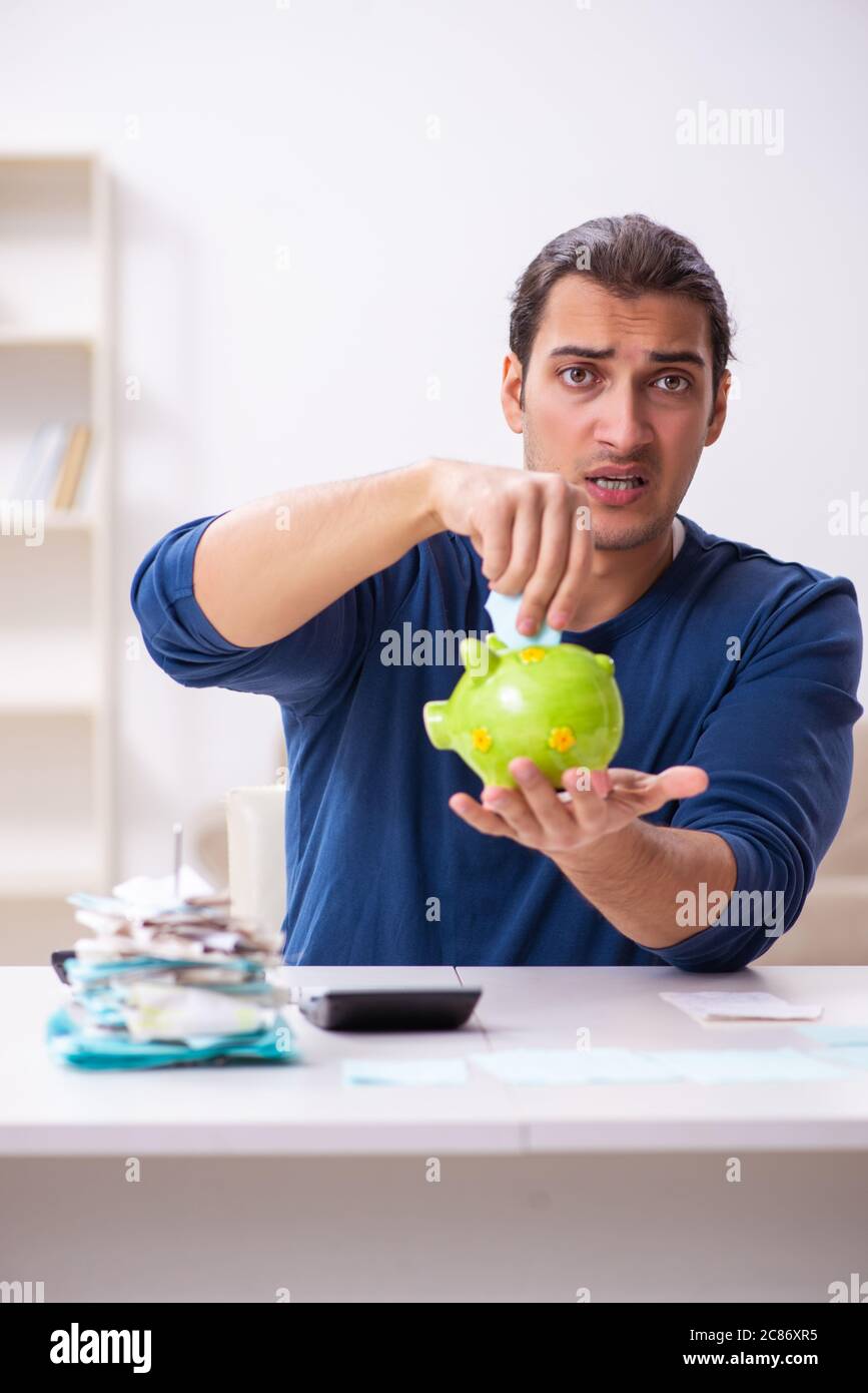Young man in the budget planning concept Stock Photo - Alamy