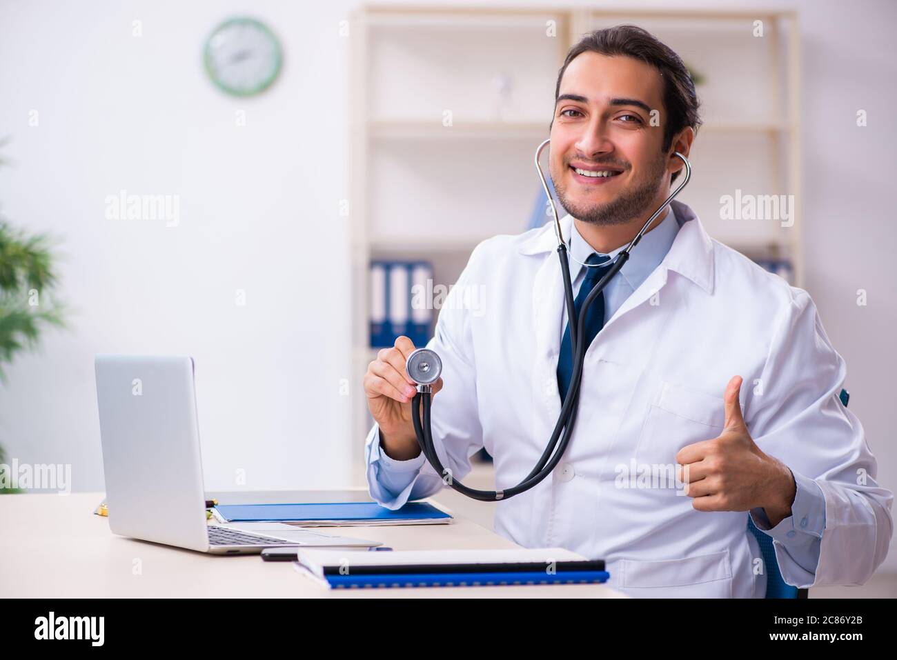 Handsome doctor giving thumb up hi-res stock photography and images - Alamy