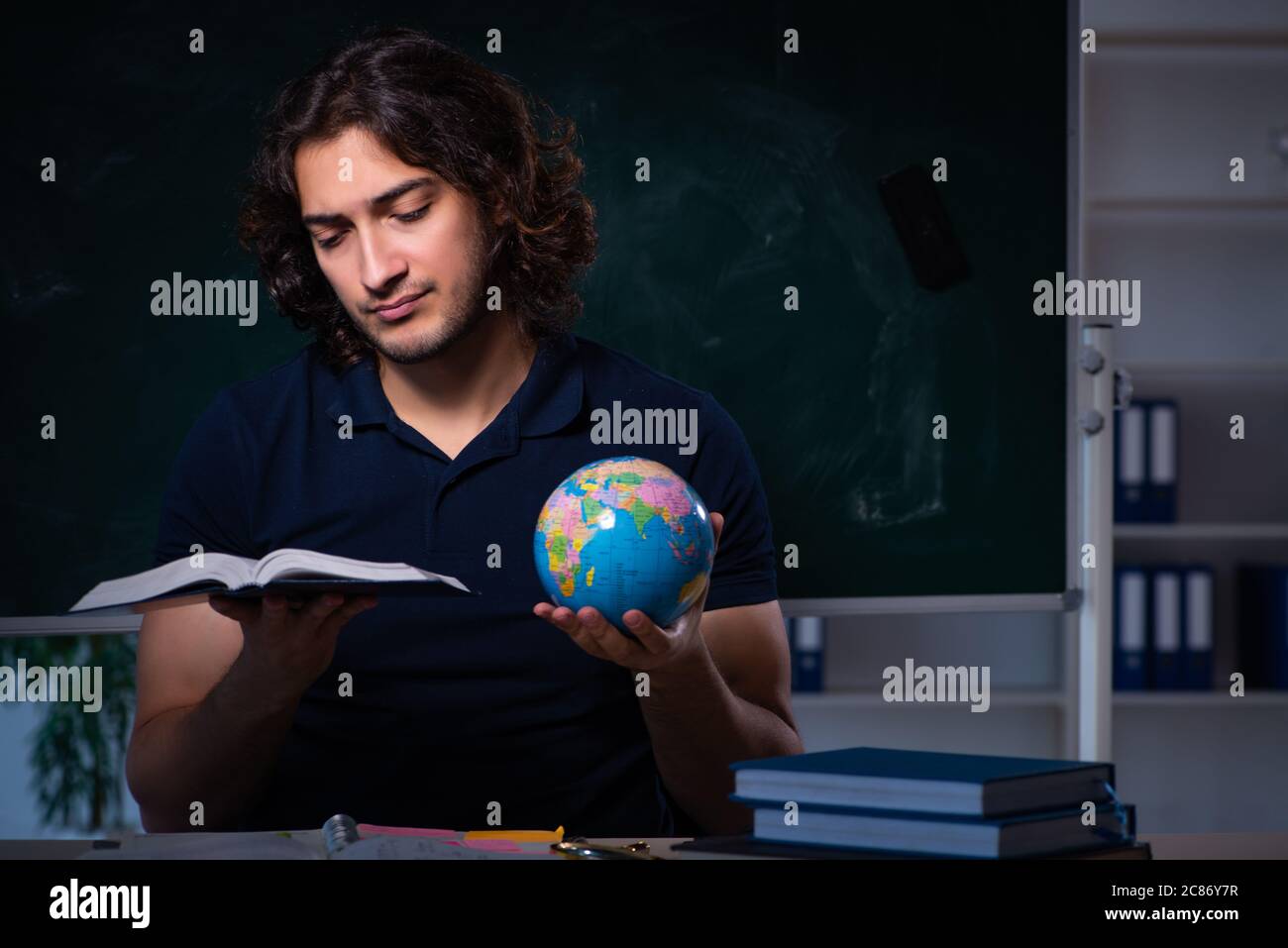 Young student in the classroom at night Stock Photo - Alamy