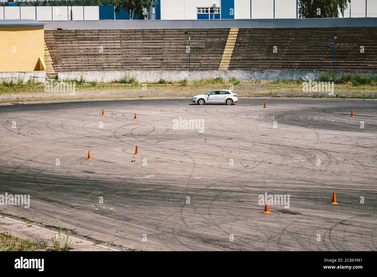 Car and traffic cones, driving school concept. Training car performs ...