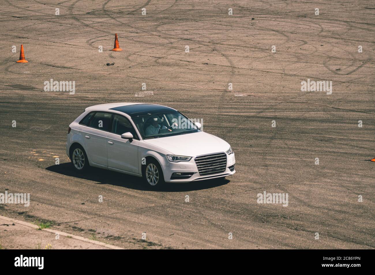 Car and traffic cones, driving school concept. Training car performs ...