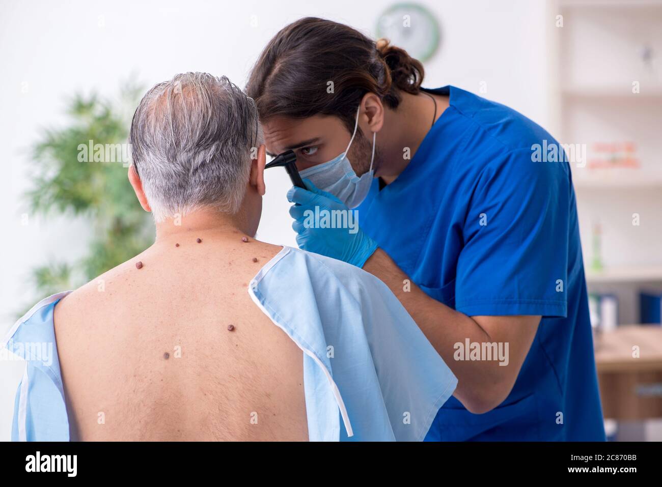 Old man visiting male doctor dermatologist Stock Photo - Alamy