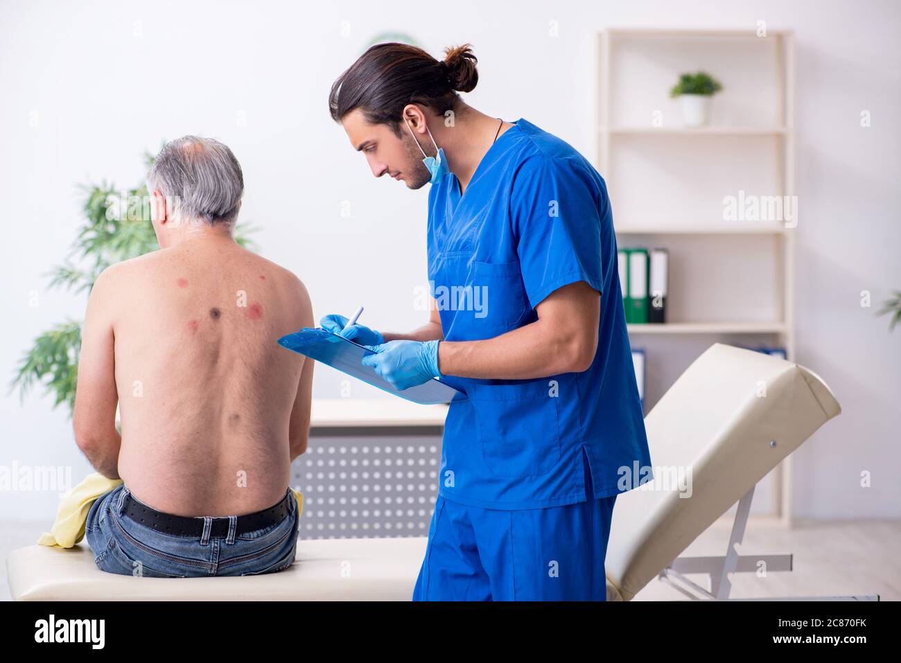 Old man visiting male doctor dermatologist Stock Photo - Alamy