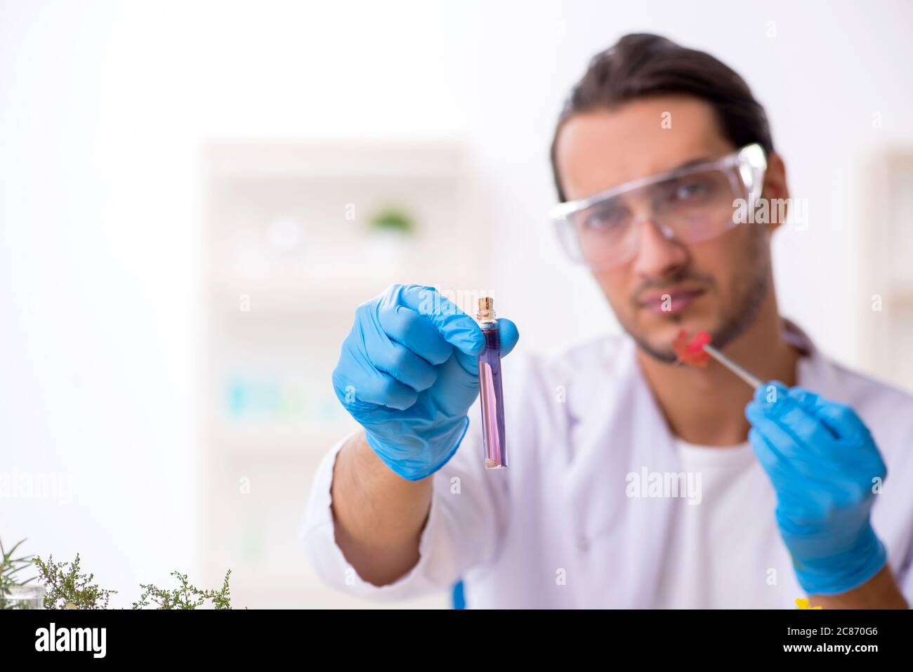 Young chemist in perfume synthesis concept Stock Photo - Alamy
