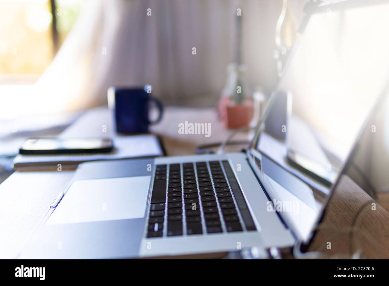 Work at home concept with beautiful laptop computer on desk near window ...