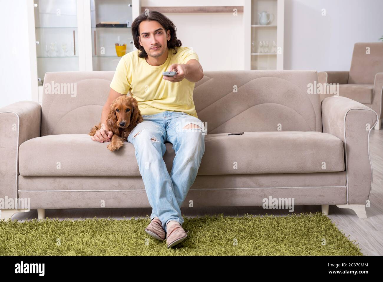 Young man with cocker spaniel Stock Photo - Alamy