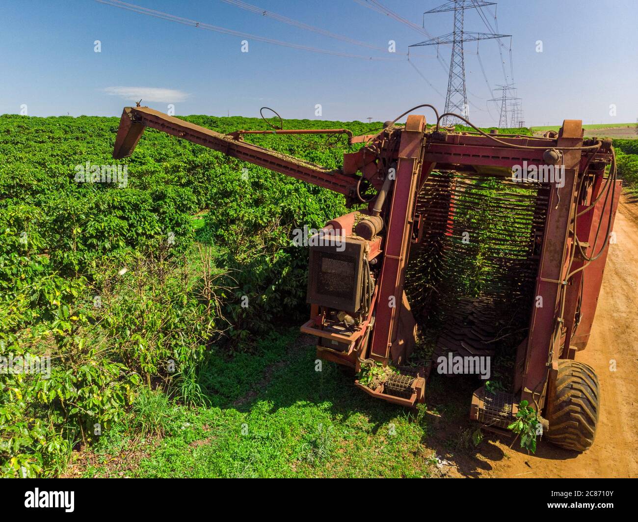 Machine in the field harvesting coffee in the plantation of Brazil ...