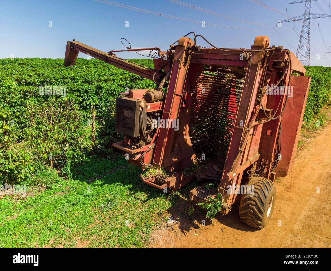 Machine in the field harvesting coffee in the plantation of Brazil ...