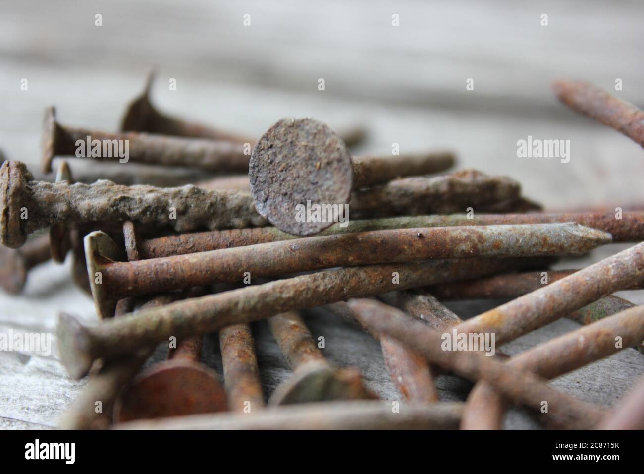 A pile of worn, rusted and out of date iron construction nails Stock ...