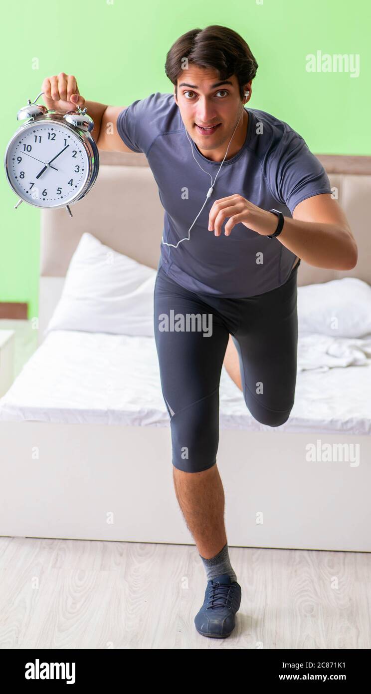 The young handsome man doing morning exercises in the hotel room Stock ...