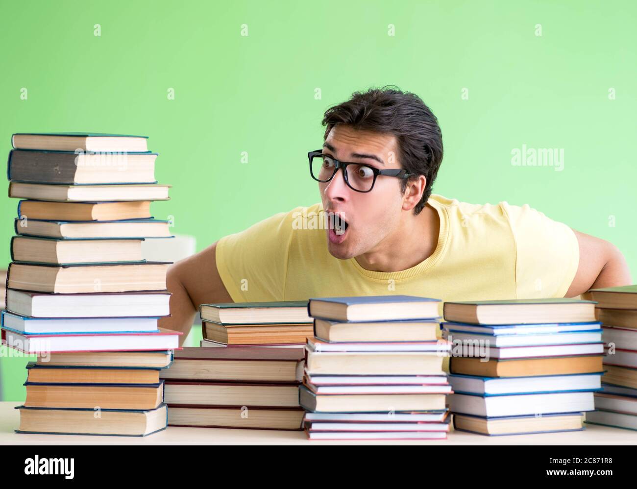 The student with too many books to read before exam Stock Photo - Alamy
