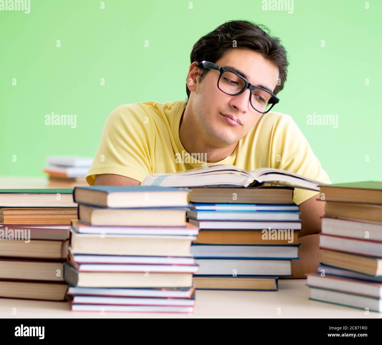 The student with too many books to read before exam Stock Photo - Alamy