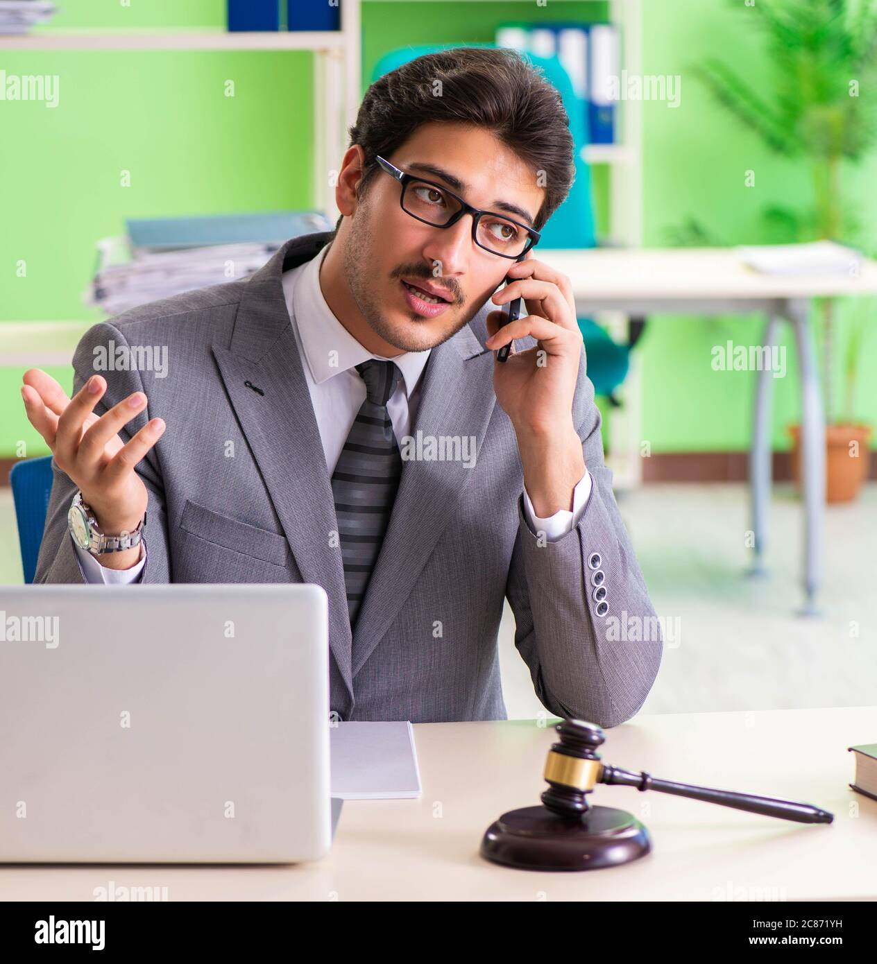 The young handsome lawyer working in the office Stock Photo - Alamy