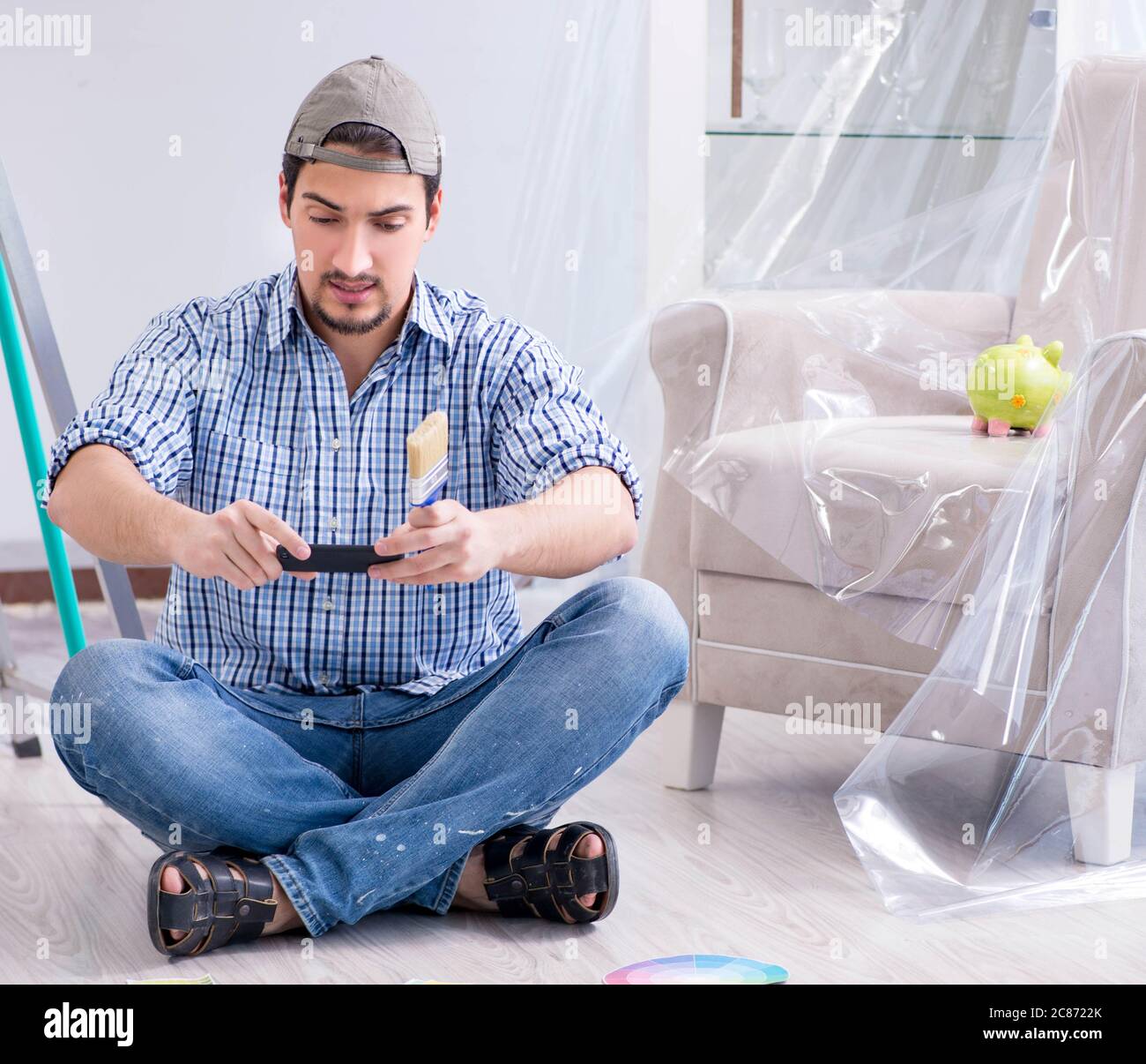 The young man contractor choosing color from rainbow Stock Photo - Alamy