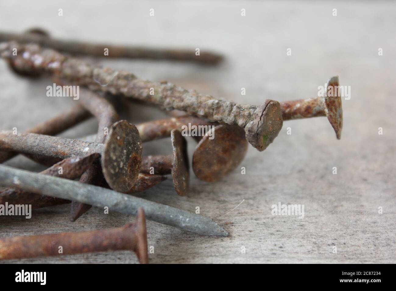 A pile of worn, rusted and out of date iron construction nails Stock ...