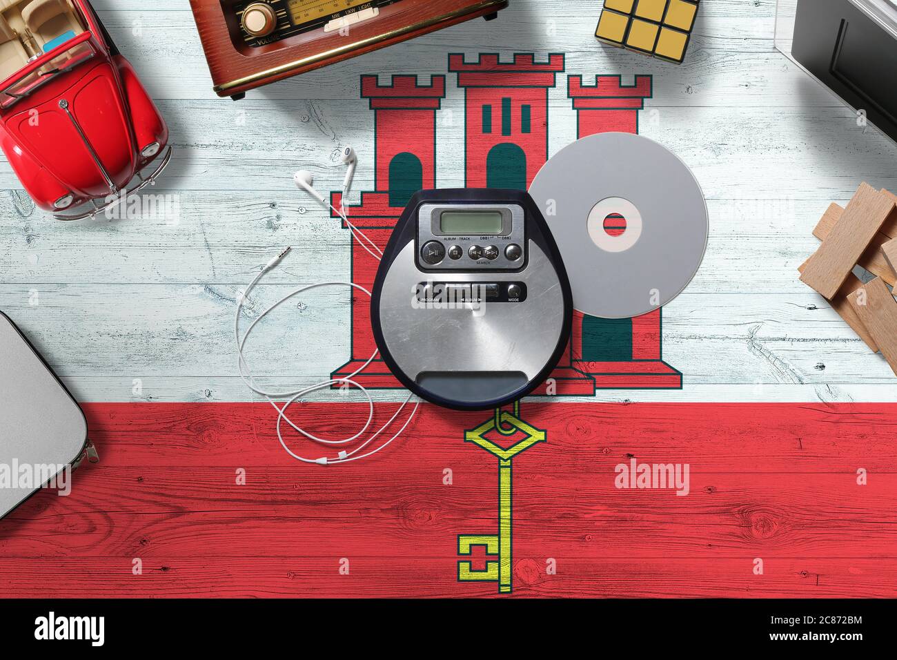 Gibraltar flag on wooden desk with retro digital media concept ...