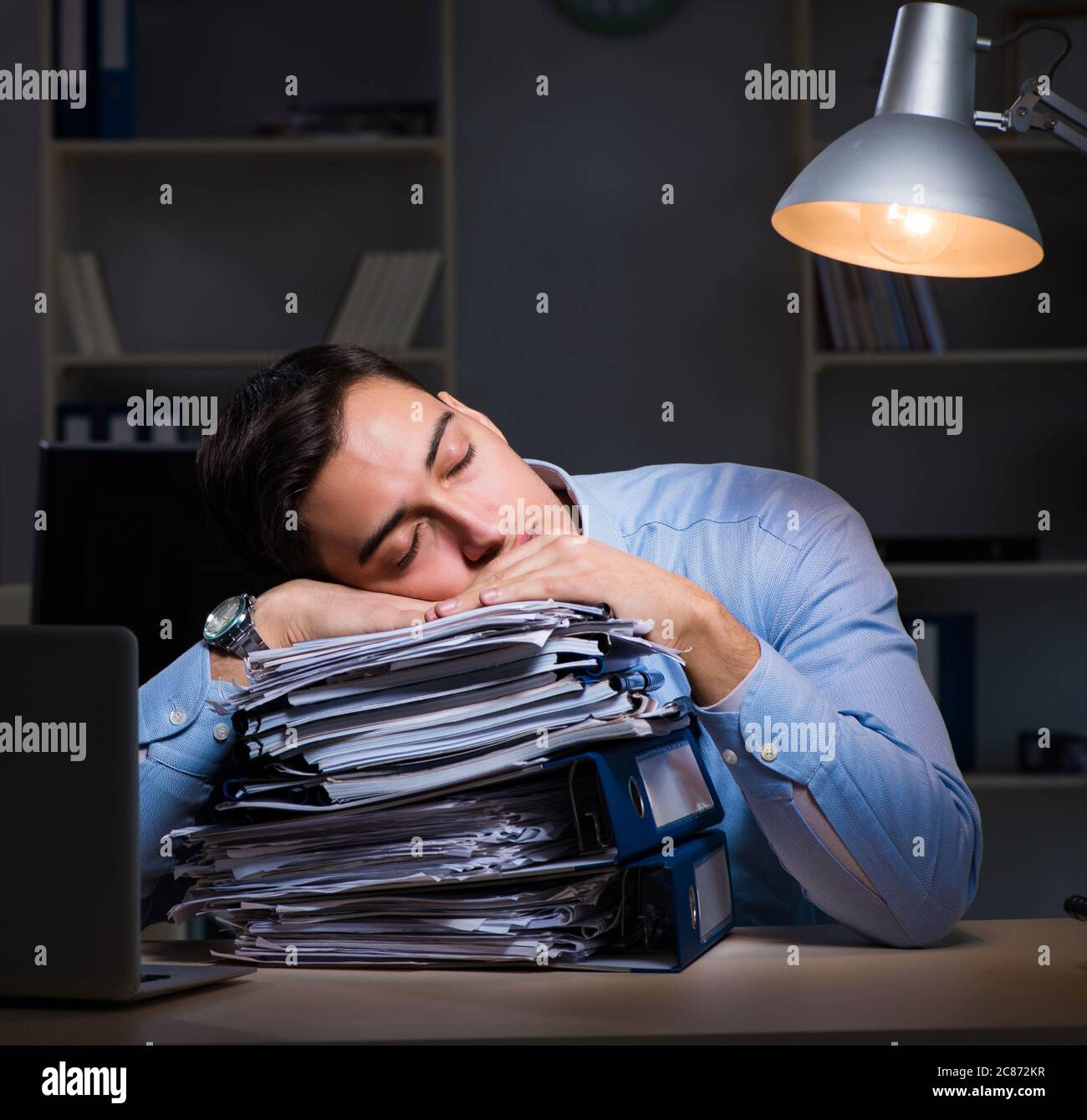 The employee working late at night at important report Stock Photo - Alamy