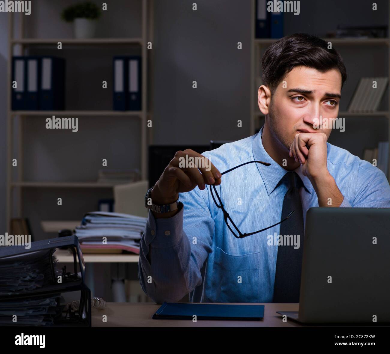 The employee working late at night at important report Stock Photo - Alamy