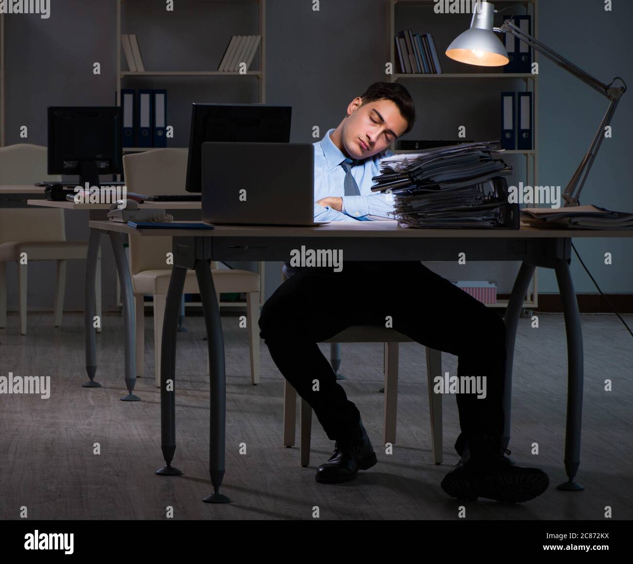 The employee working late at night at important report Stock Photo - Alamy
