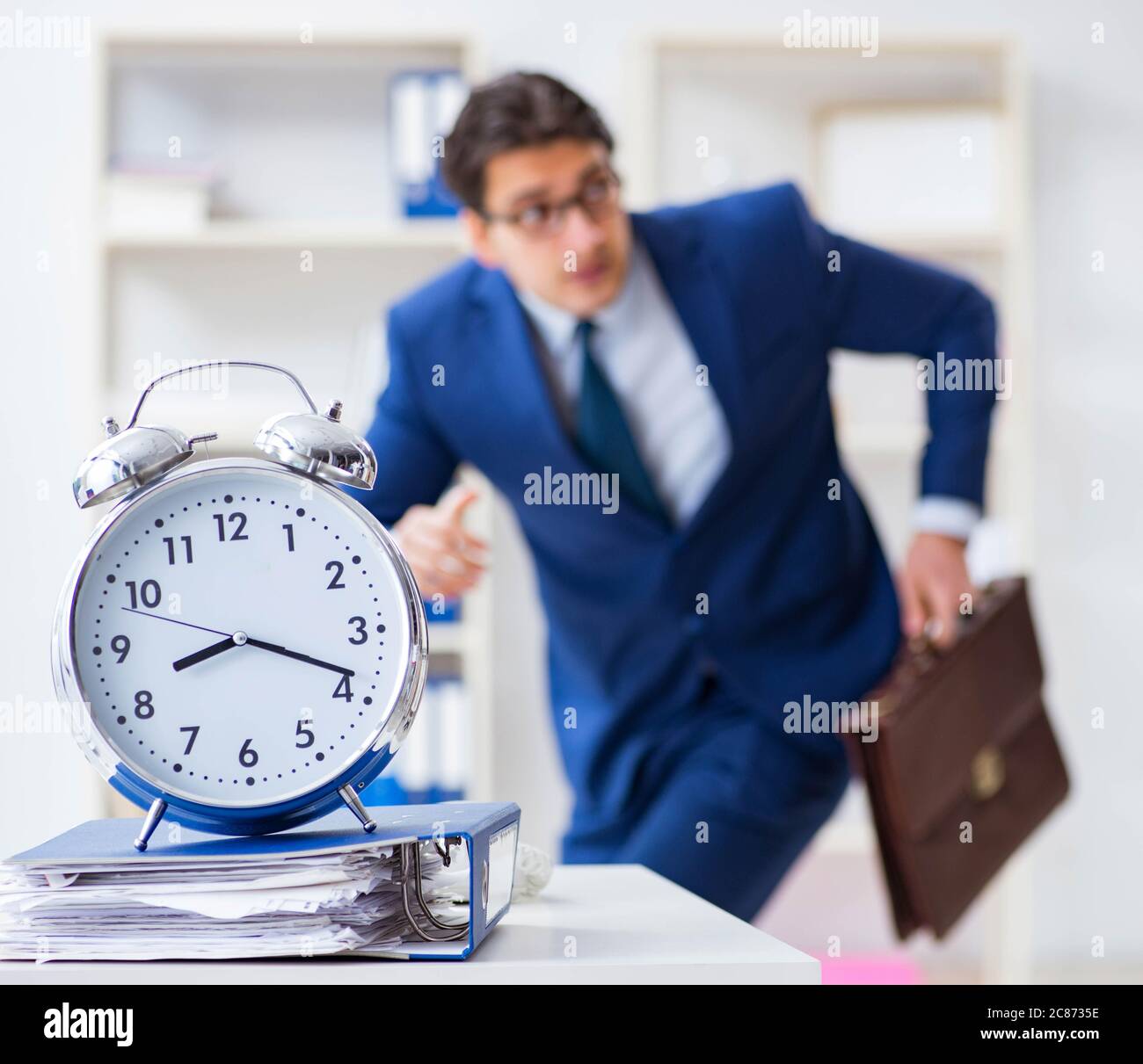 The businessman in bad time management concept Stock Photo - Alamy