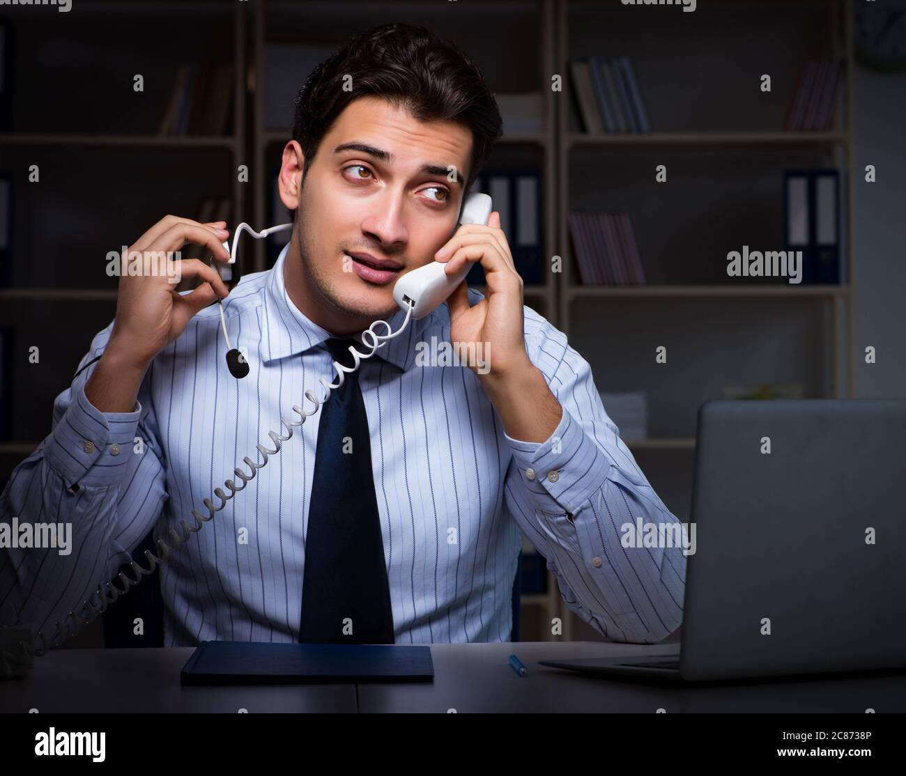The call center operator talking to customer during night shift Stock ...