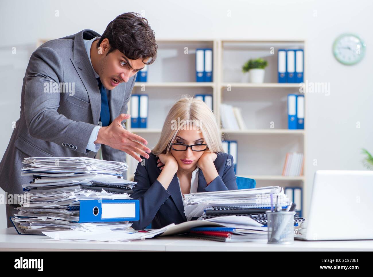 The angry irate boss yelling and shouting at his secretary employee ...