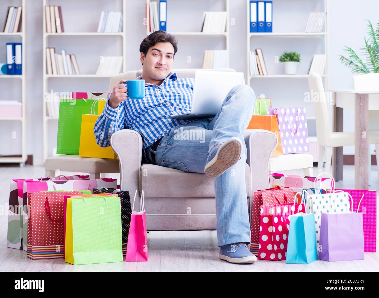 The young man after excessive shopping at home Stock Photo - Alamy