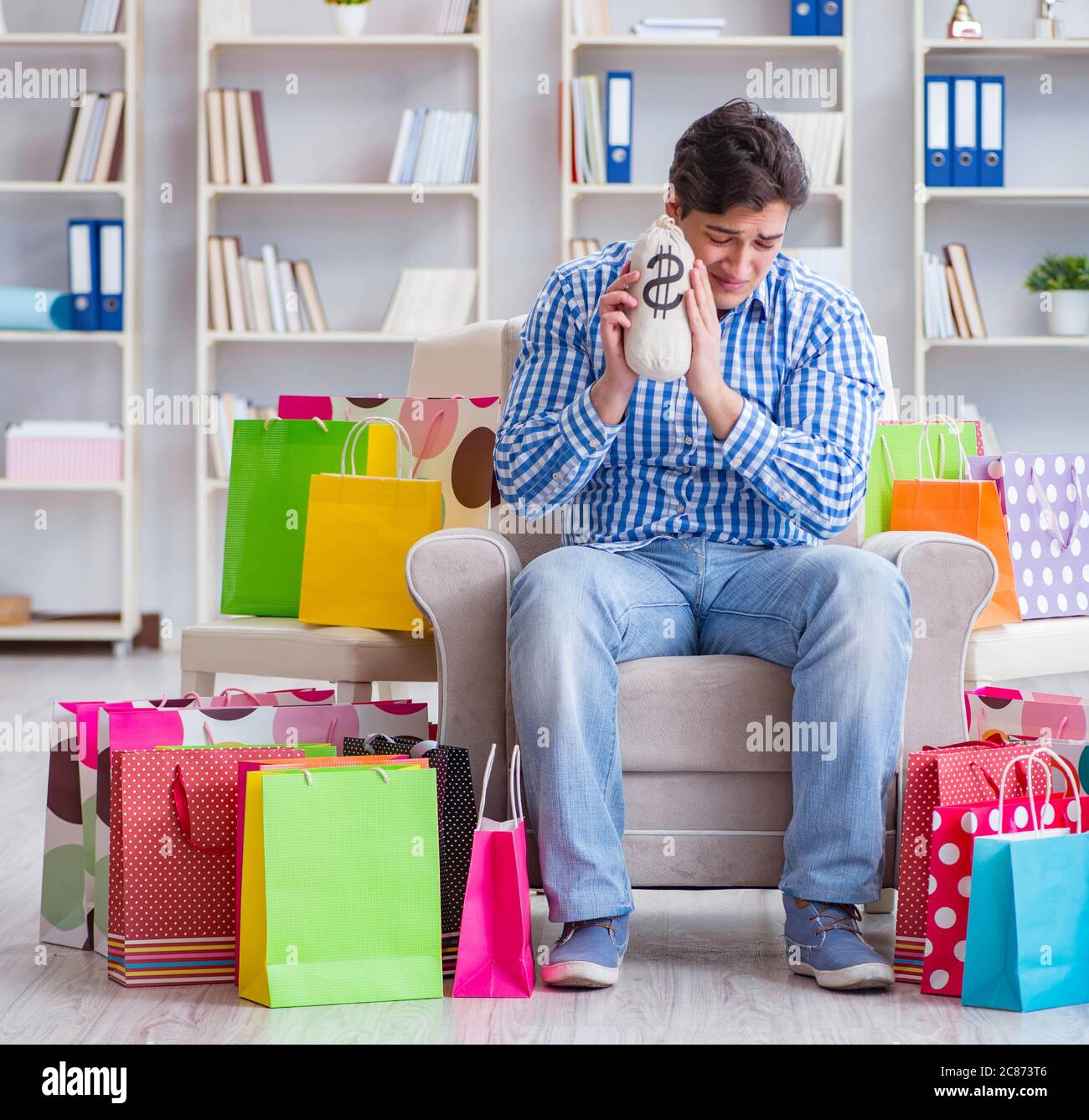 The young man after excessive shopping at home Stock Photo - Alamy