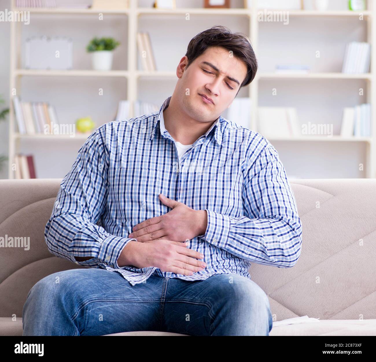 The sick man suffering at home from infection and bad stomach Stock ...