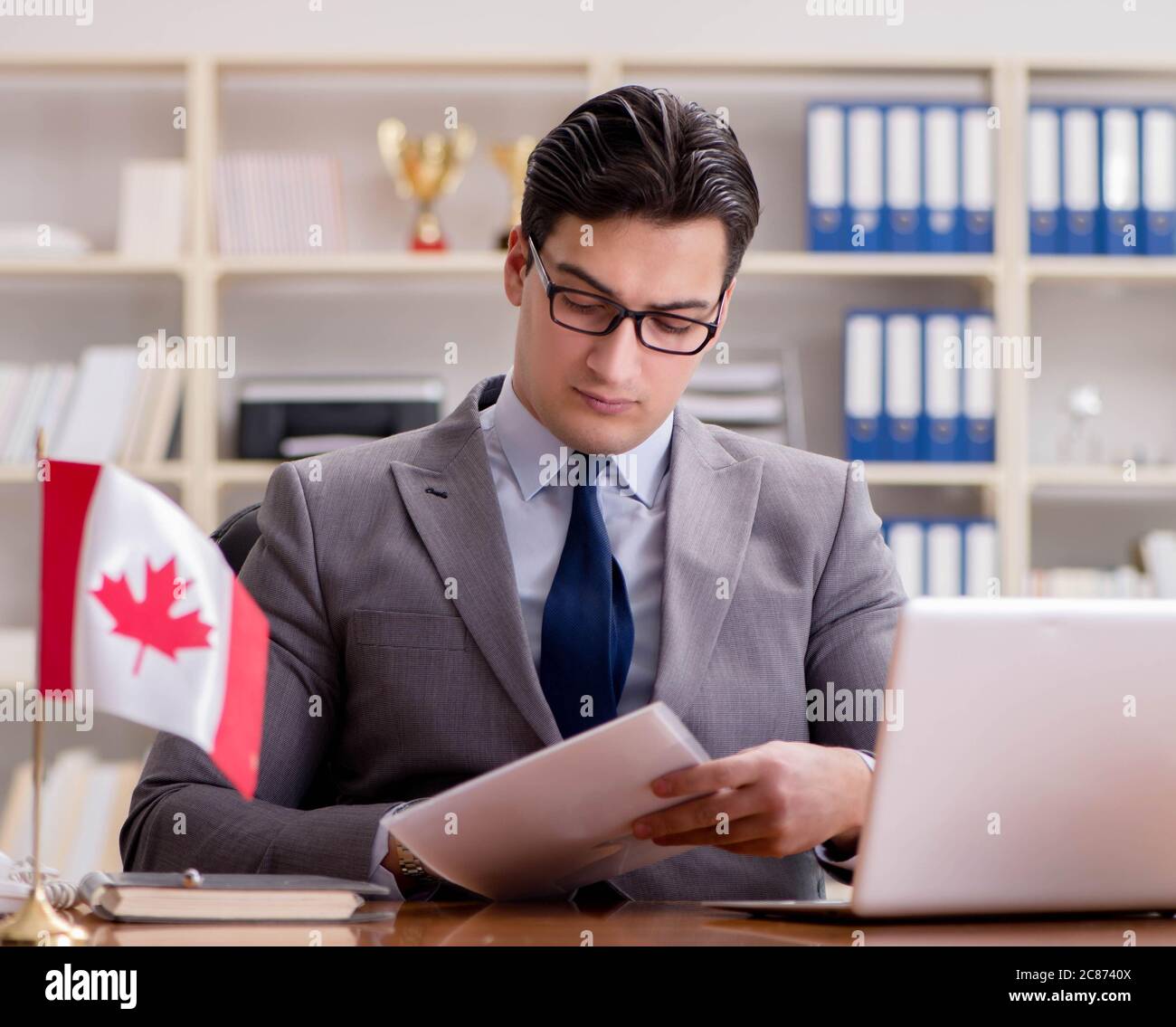 The businessman with canadian flag in office Stock Photo - Alamy