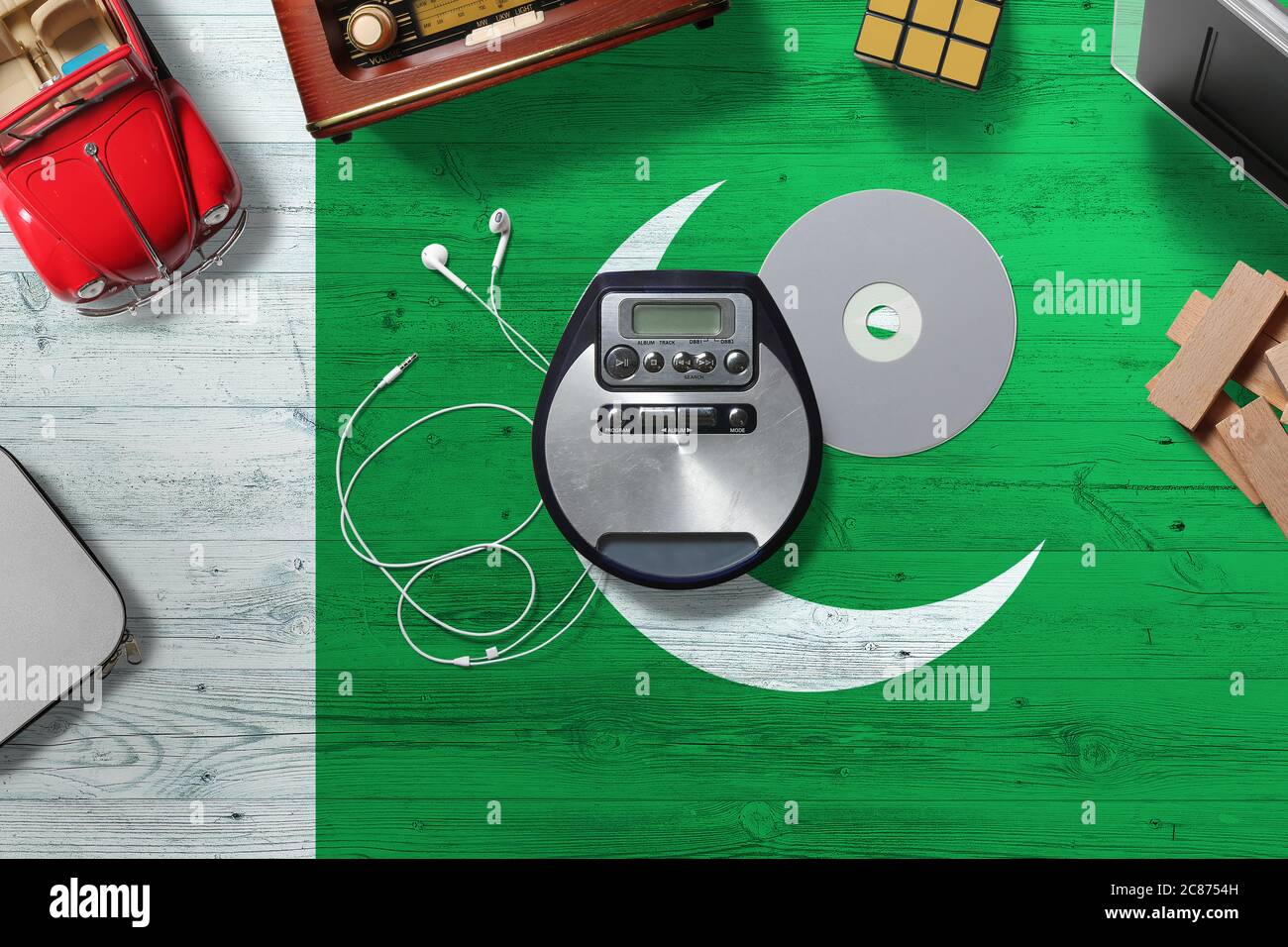 Pakistan flag on wooden desk with retro digital media concept. National ...