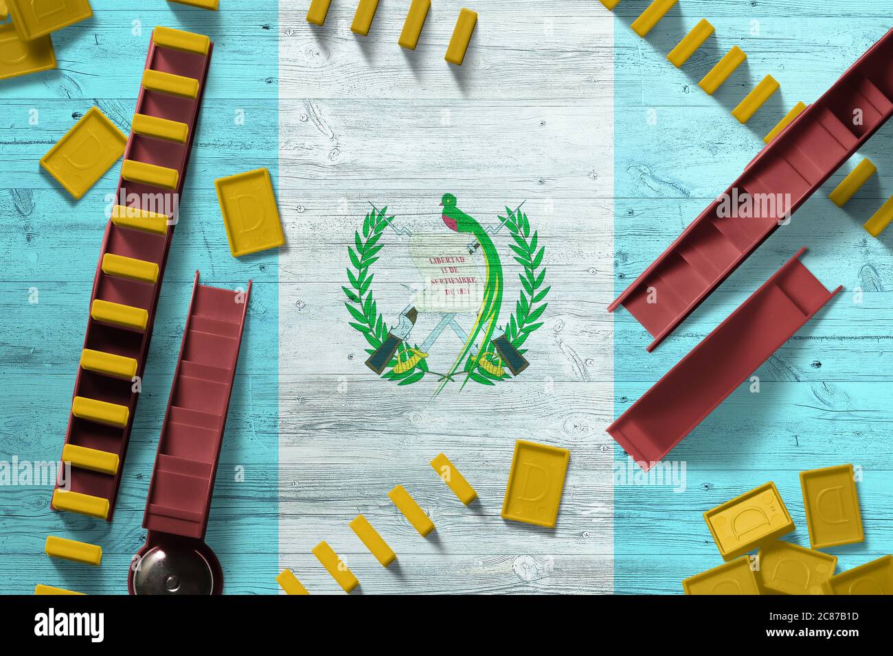 Guatemala flag with national background with dominoes on wooden table ...