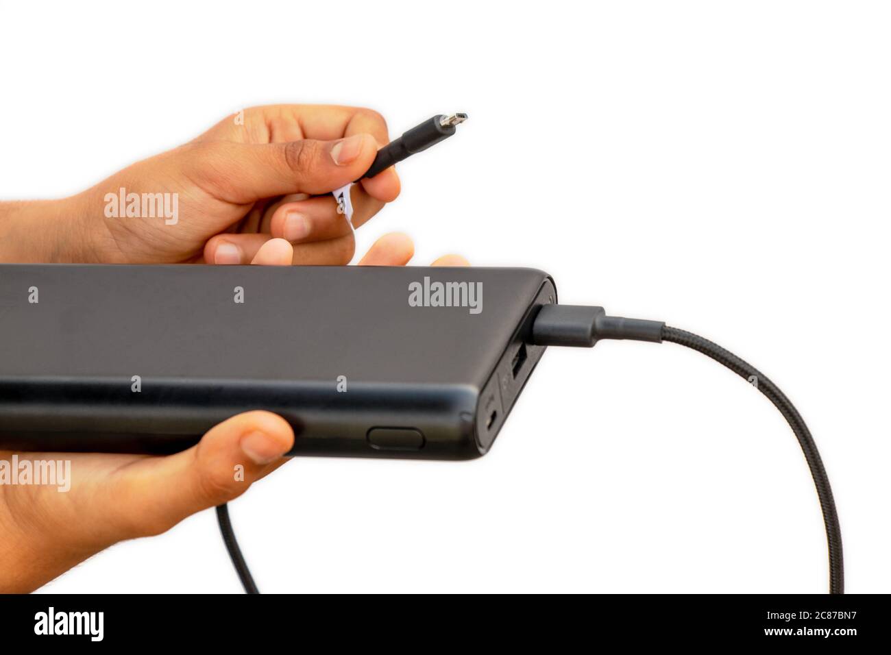 Hands showing battery charger (Power bank) with usb charging cable ...